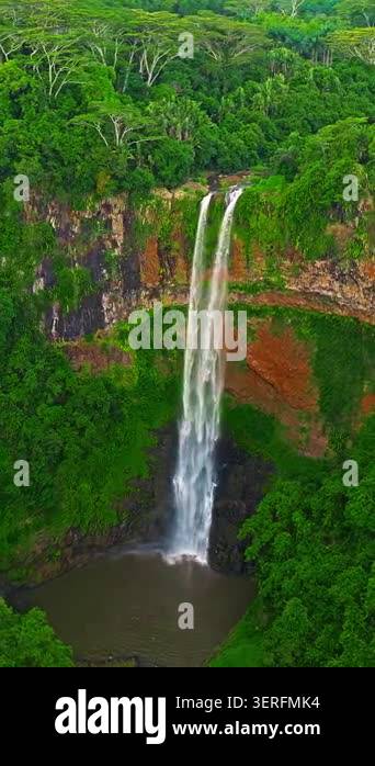 Aerial view of Chamarel Waterfall, plunging from verdant cliff into ...