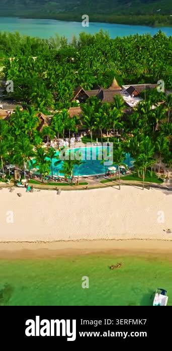 Aerial view of crystal water on the seashore, Mauritius with palm trees ...