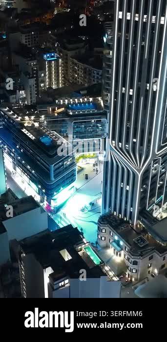 Aerial of night view of Paceville, St. Julians city with modern towers ...