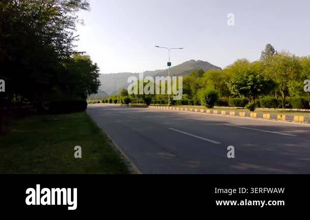 Scenic Empty Road Through Green Landscape with Mountain View and Clear ...
