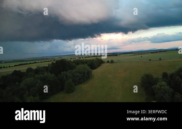 Aerial drone view of massive storm clouds moving across the landscape ...