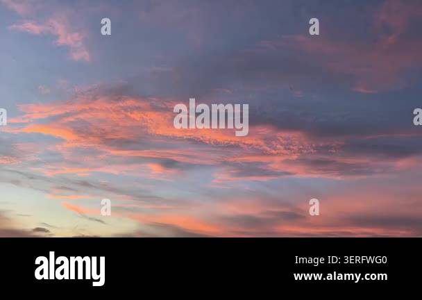 Pastel sunset sky with soft pink clouds and serene evening atmosphere ...