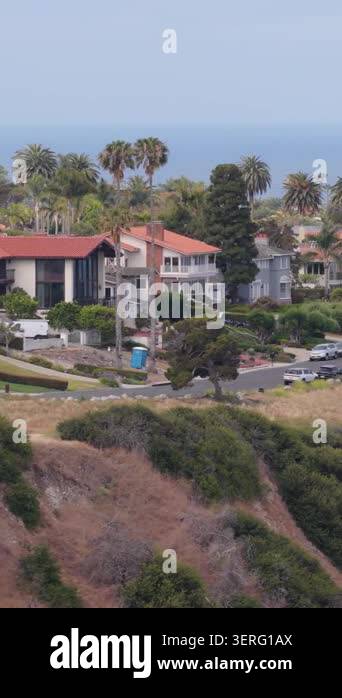 Luxurious hillside villas with red tiled roofs and palm trees on Palos ...