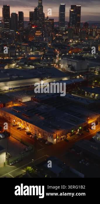High angle view of buildings along illuminated streets. tilt up ...