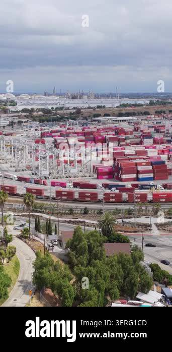 Long cargo train traveling through busy Port of Los Angeles container ...