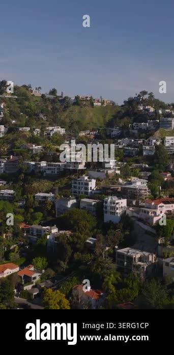 Aerial ascending footage of residencies and villas on slope in ...