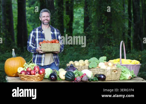 Hispanic Farmer with a basket full of fresh potatoes and carrots ...