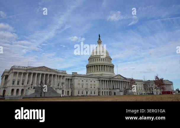 American flag flying over Capitol. American flag with sky clouds over ...