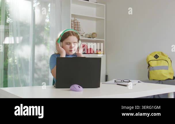 Singing child uses headphones during class. Singing teenager joins ...
