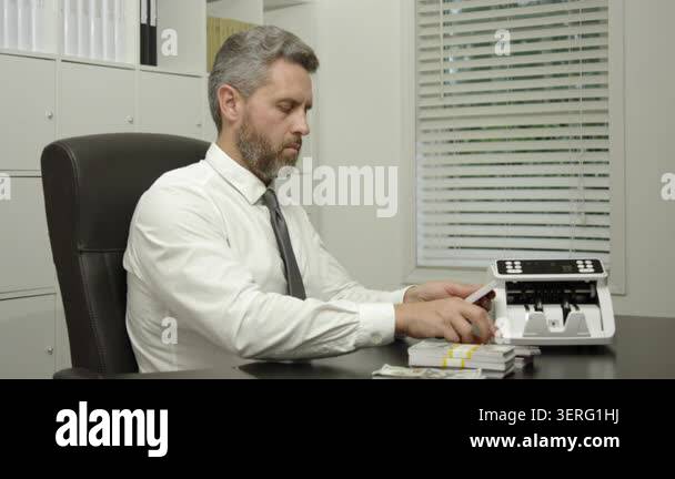 Banker counting cash in office. Banker managing finance. Banker ...
