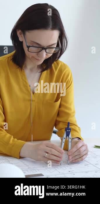 Woman architect focusing on architectural designs, developing precise ...