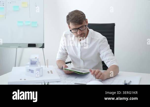 Architect brainstorming innovative construction concepts, tapping a ...