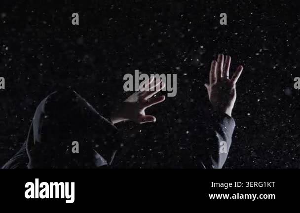 Thriller scene shows hooded figure. Thriller man moves through storm ...