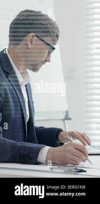 Architect or engineer working on a construction project, using a laptop ...