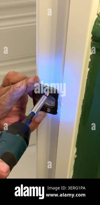 Men's hands repairing a door, door lock Apartment renovation, worker ...