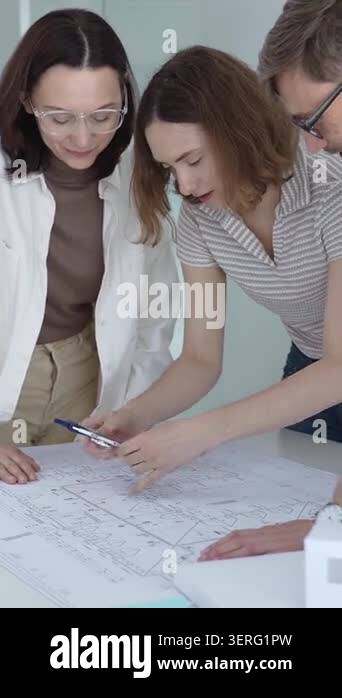 Diverse team of architects and engineers collaborating on complex ...