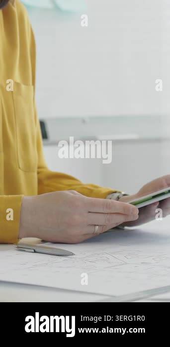 Woman architect or engineer sitting at her office desk, navigating a ...