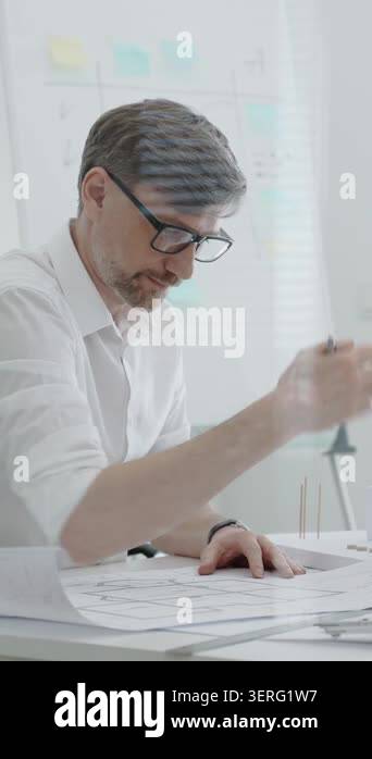 Architect hands designing blueprints for a new construction project ...