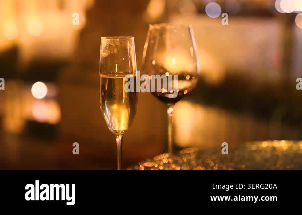 Elegant glasses in warm evening restaurant ambiance with urban bokeh ...