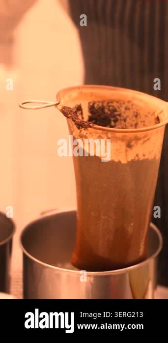 Traditional tea preparation in food service with big iron kettle ...