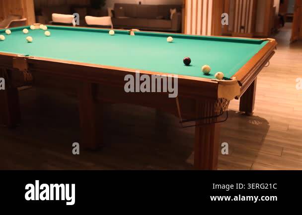 Luxury pool hall interior with billiard table green cloth and balls ...