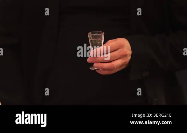 Dark bar atmosphere hand with vodka shot glass toast celebration. High ...
