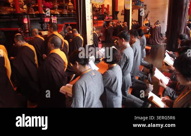 Group of people in traditional robes attending a religious ceremony ...
