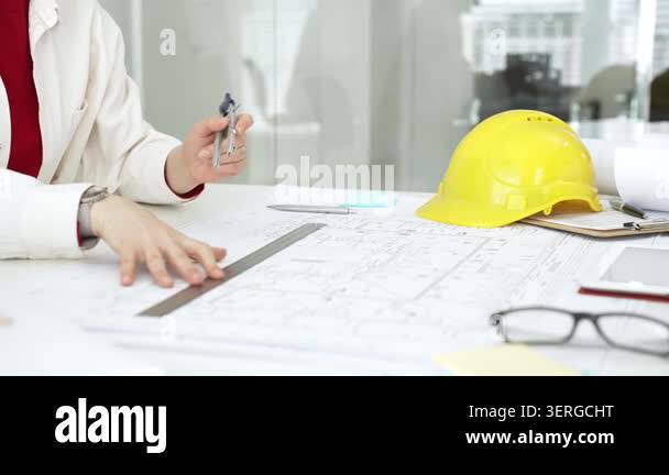 Professional woman drafting architectural blueprints using drawing ...