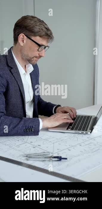 Young professional male architect or engineer focused on a computer ...