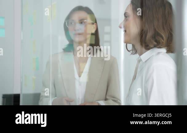 Professional businesswomen discussing new strategies and collaborating ...