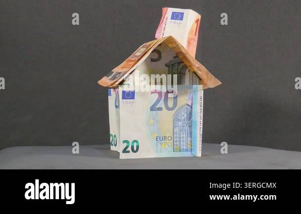 Frontal close-up view of a three dimensional house built with folded ...