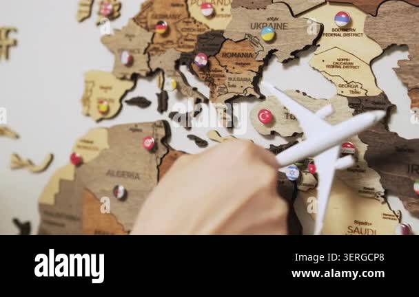 Woman exploring travel concept with plane above wooden map Stock Video ...