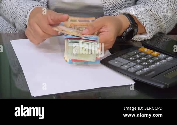 High angle view of hands counting euro bills with bank teller technique ...