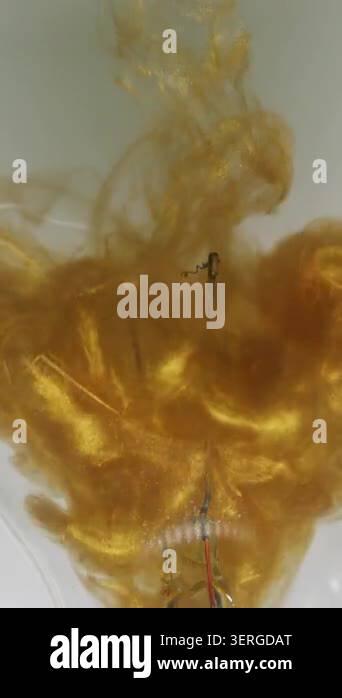 Vertical video. Swirling fog fluid. Paint background. Defocused golden ...