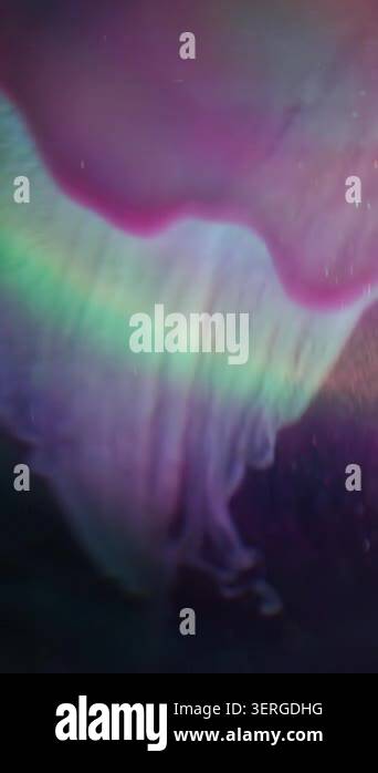 Vertical video. Dripping glitter. Defocused art splash. Shimmering ink ...
