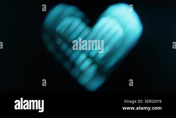 Fluorescent heart. Blur romantic sign. Defocused neon blue green color ...