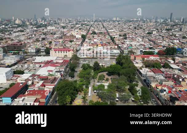 Dynamic drone view flying forward above Guadalajara city. Showcases the ...
