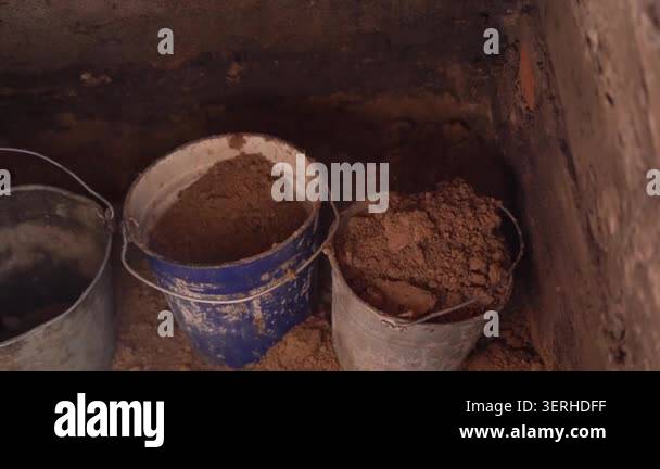 Buckets filled with soil inside vehicle inspection pit during garage ...