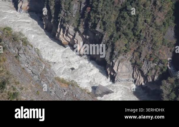 Aerial view of powerful river flowing through steep rocky gorge with ...