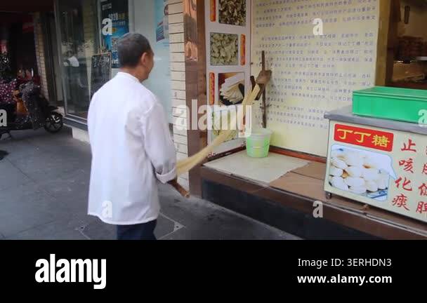 Man making traditional Chinese sugar candy by hand, stretching and ...