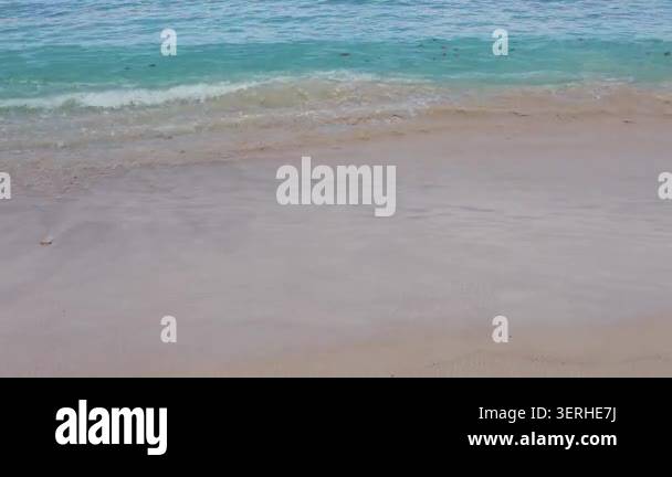 Tranquil seaside with smooth flowing waves, calm tropical beach under a ...