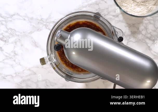 Overhead shot of stand mixer blending brown cookie dough mixture in ...