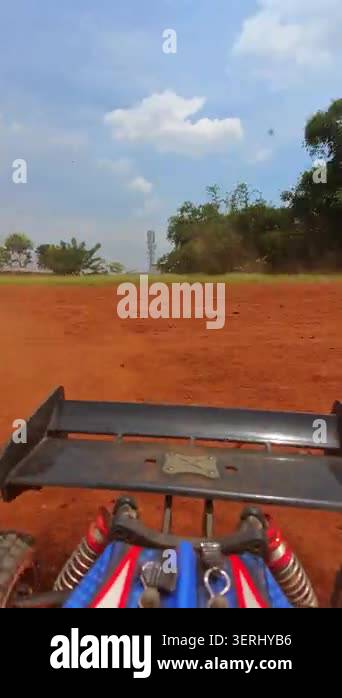 Vertical video of racing on dirt fields. Off-road vehicle speeds over ...