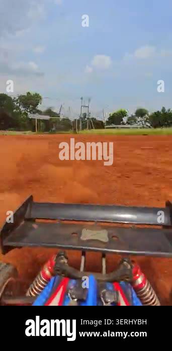 Vertical video of racing on dirt fields. Off-road vehicle speeds over ...