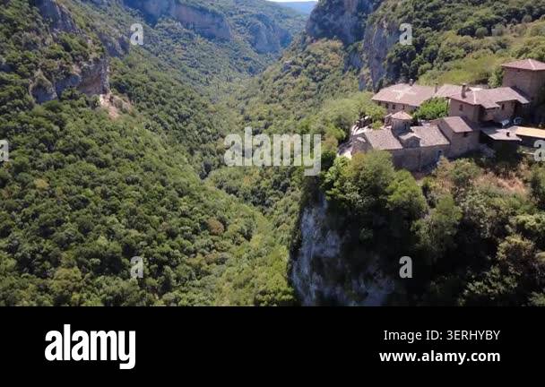 A historic Orthodox monastery with Byzantine architecture stands above ...