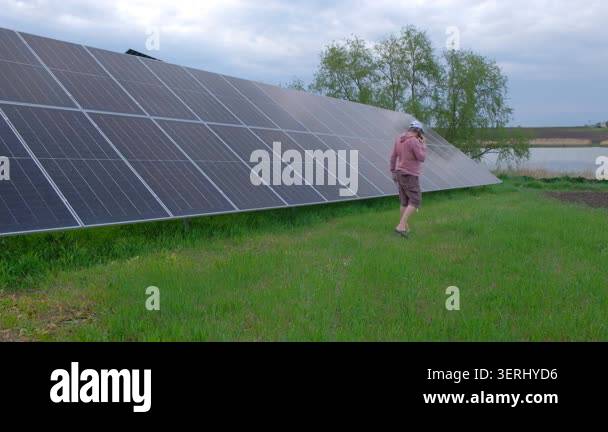 a young man with a backpack and a solar panels. solar panels. solar ...