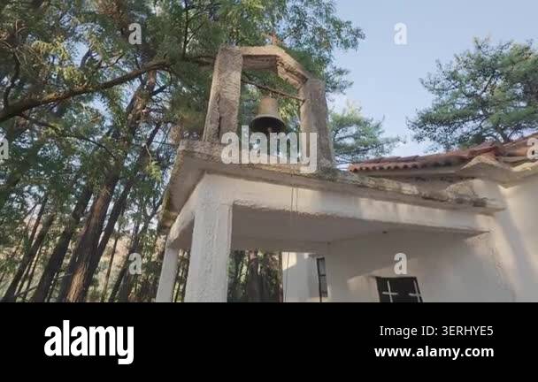 A small mountain church with traditional architecture is surrounded by ...