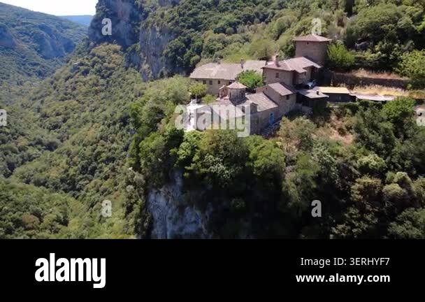 Inside a deep gorge with dense Mediterranean vegetation stands the ...