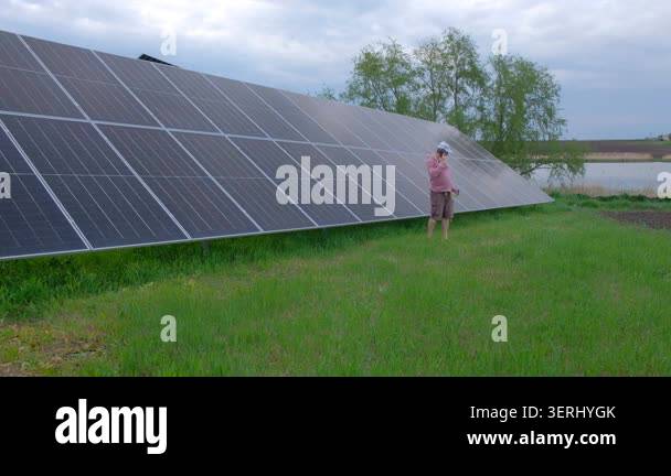 young woman with solar panels on the roof of an old house in the ...