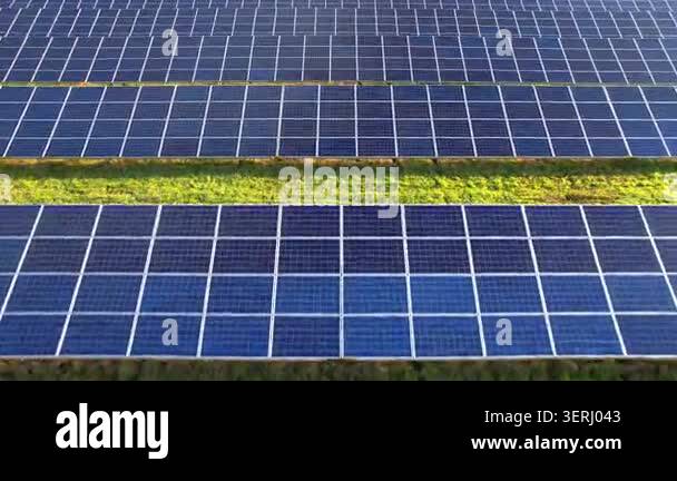 Drone footage of blue solar modules covering large renewable power site ...